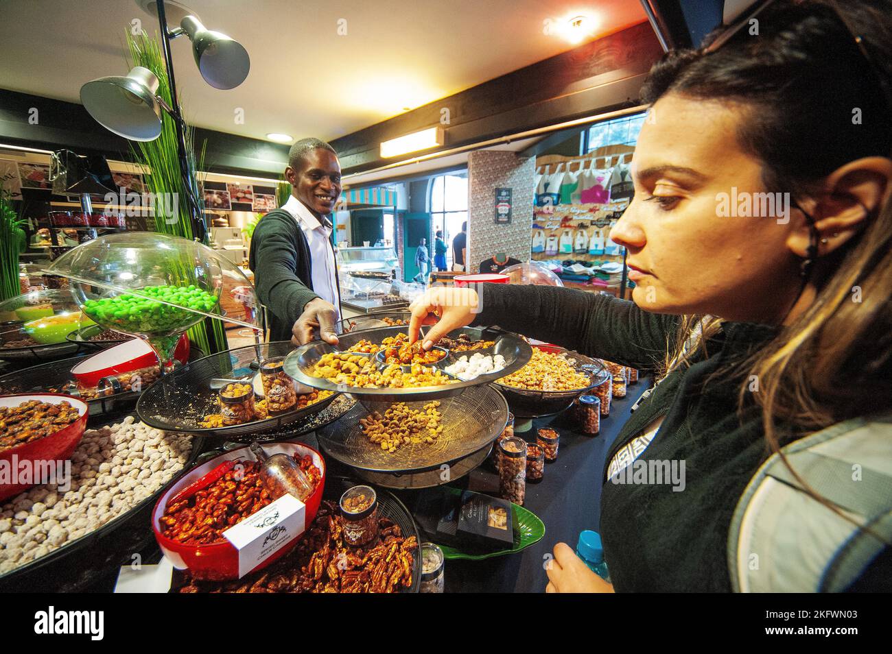 Tourists enjoying snacks at the V & A Foodmarket, V & A Waterfront ...