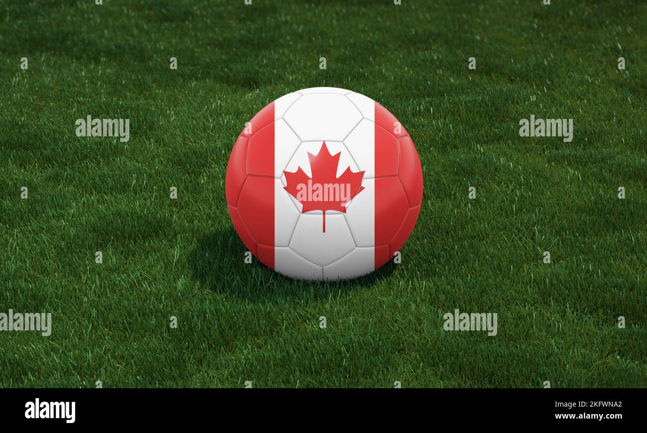 Soccer ball with Canada flag colors at a stadium on green grasses ...