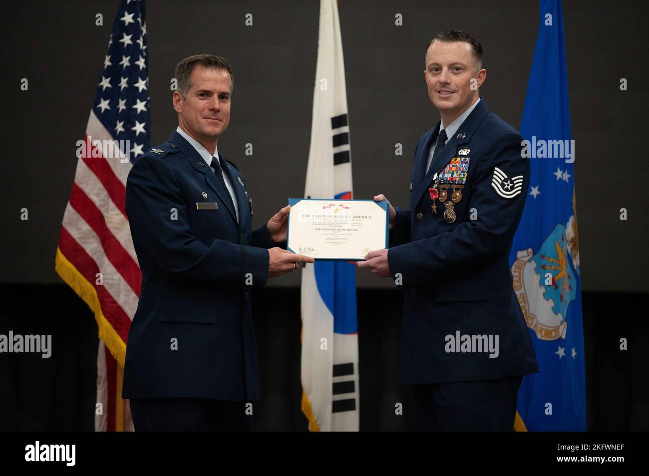 U.S. Air Force Col. Joshua Wood, 51st Fighter Wing Commander, presents ...