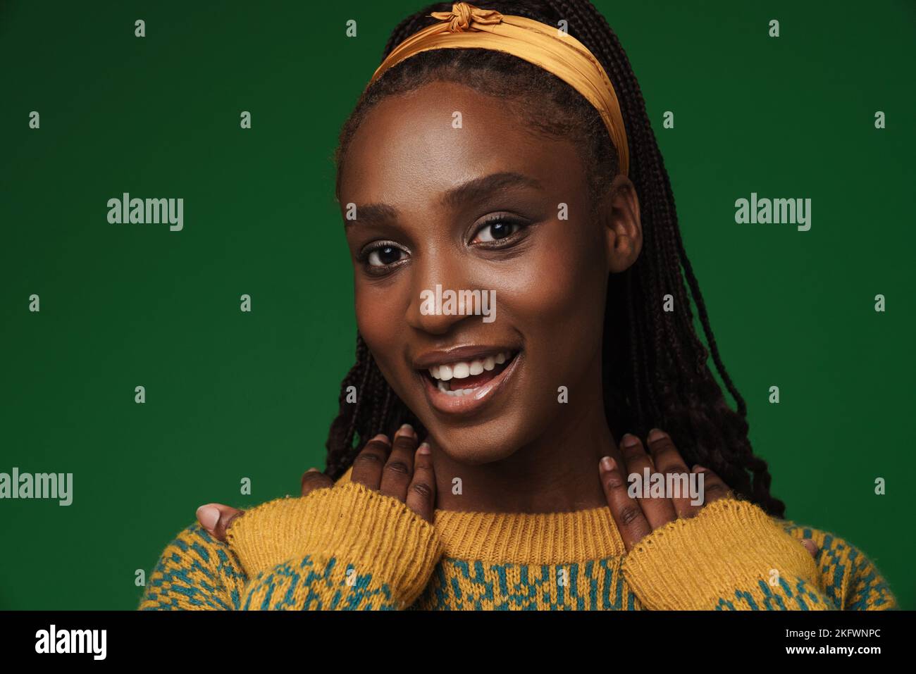 Young black woman with afro pigtails smiling and looking at camera ...
