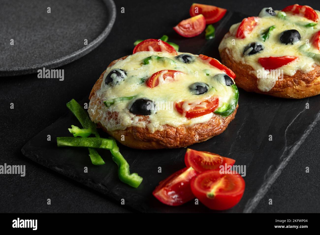 Homemade pizza on a small tortilla. Mini pizza Stock Photo - Alamy