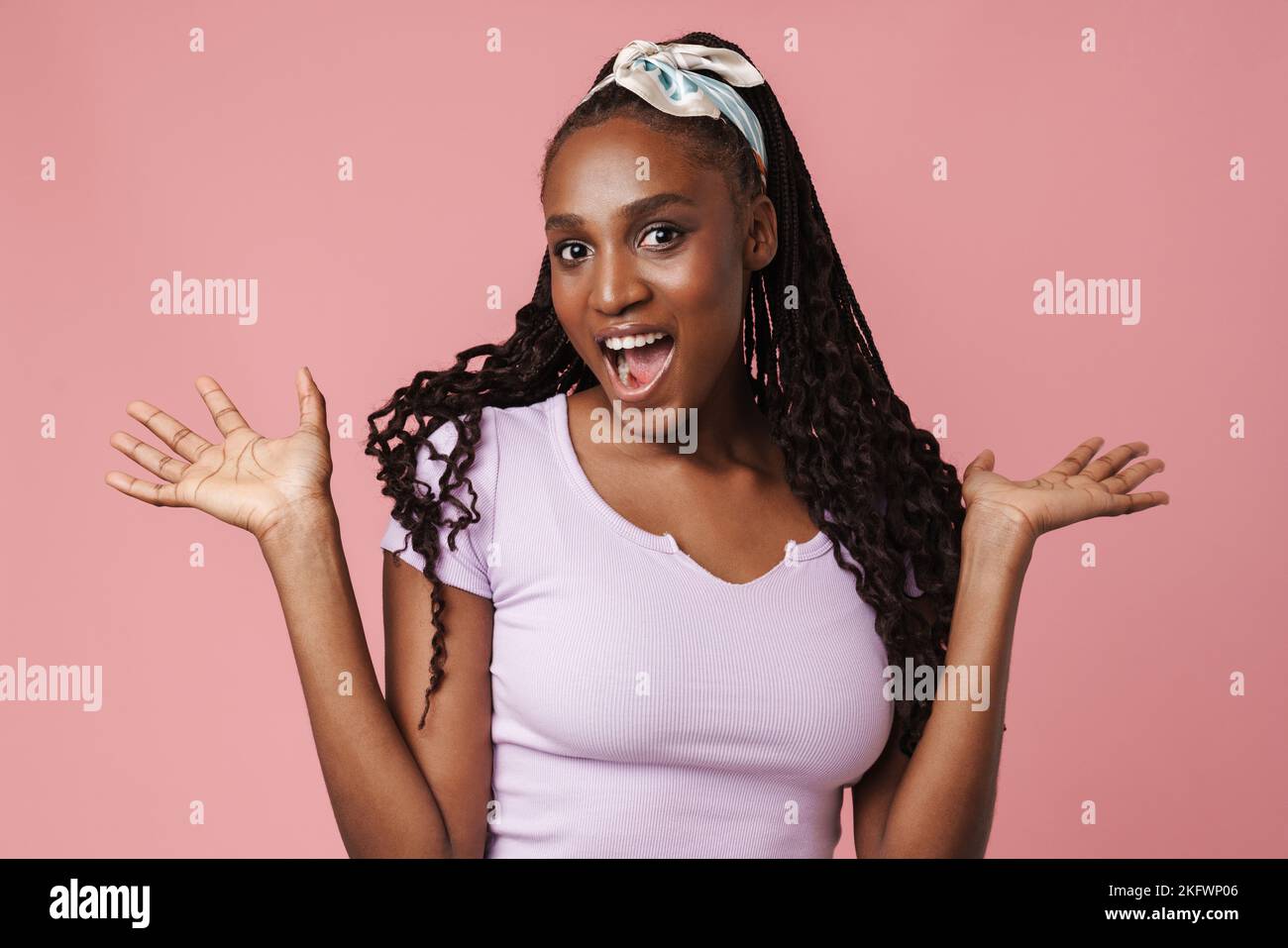 Young Black Woman Wearing Headband Expressing Surprise At Camera
