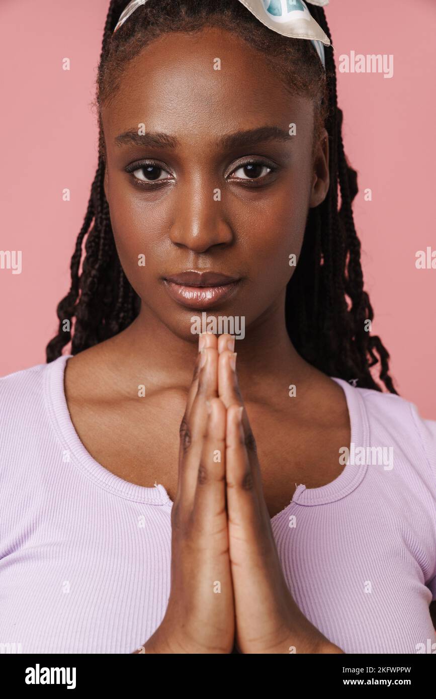 Young black woman with afro pigtails looking at camera and gesturing ...