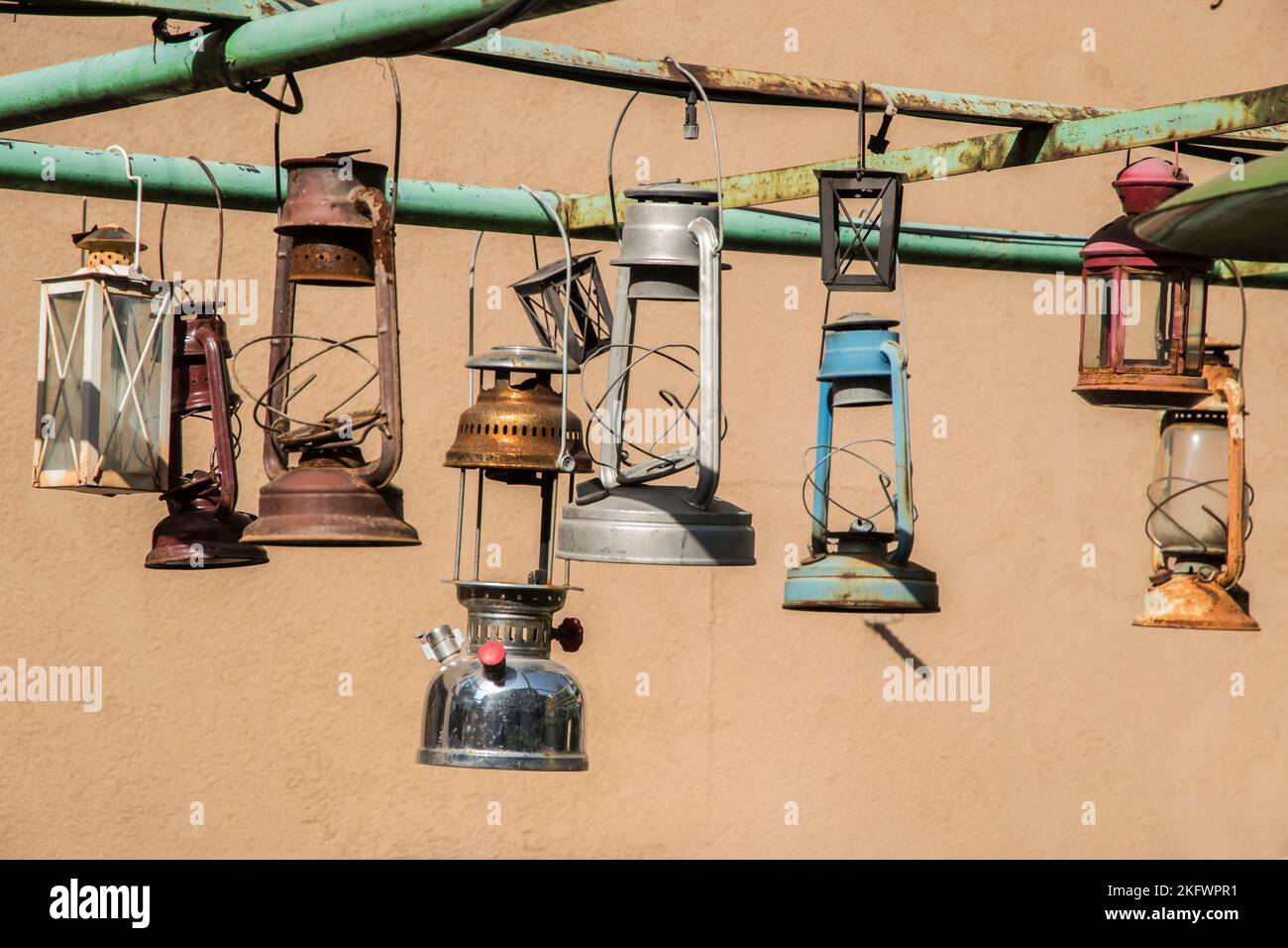 Hanging old used vintage gas lamps in house garden closeup in sunny day ...