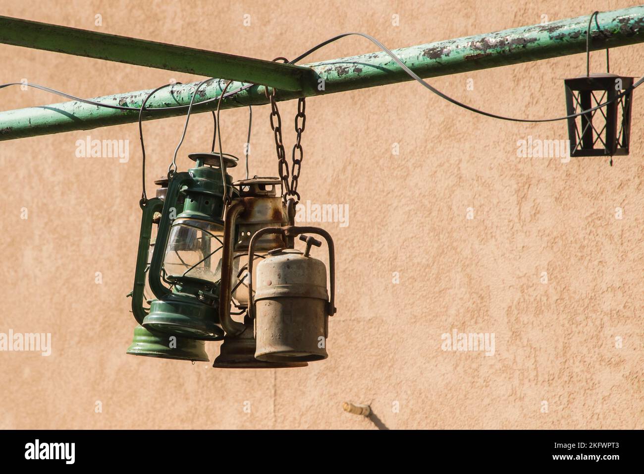 Hanging old used vintage gas lamps in house garden closeup in sunny day ...