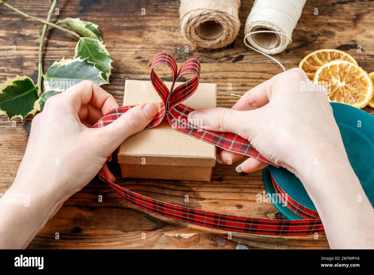 Wrapping Christmas gifts. Hobby time Stock Photo - Alamy