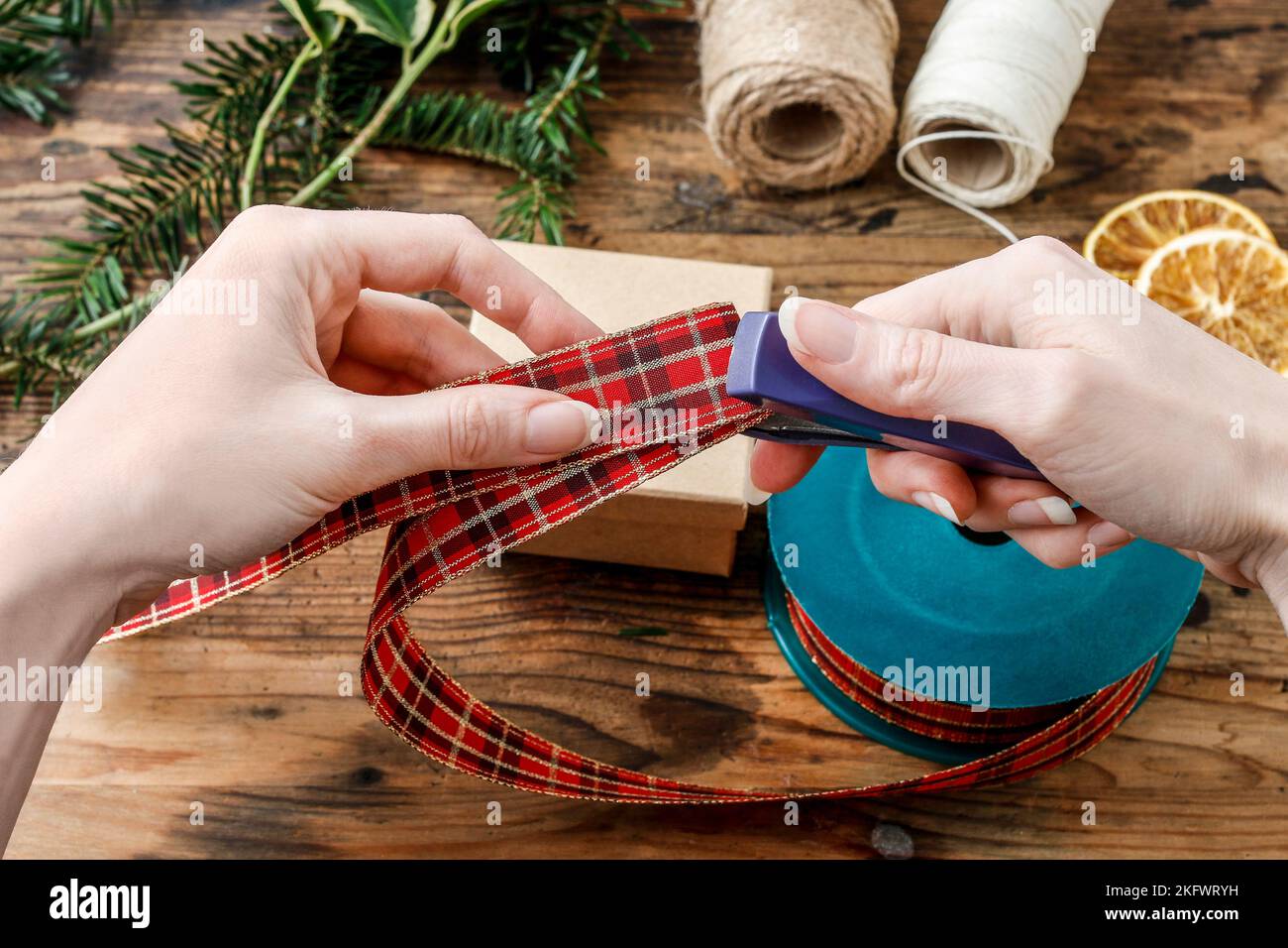 Wrapping Christmas gifts. Hobby time Stock Photo - Alamy