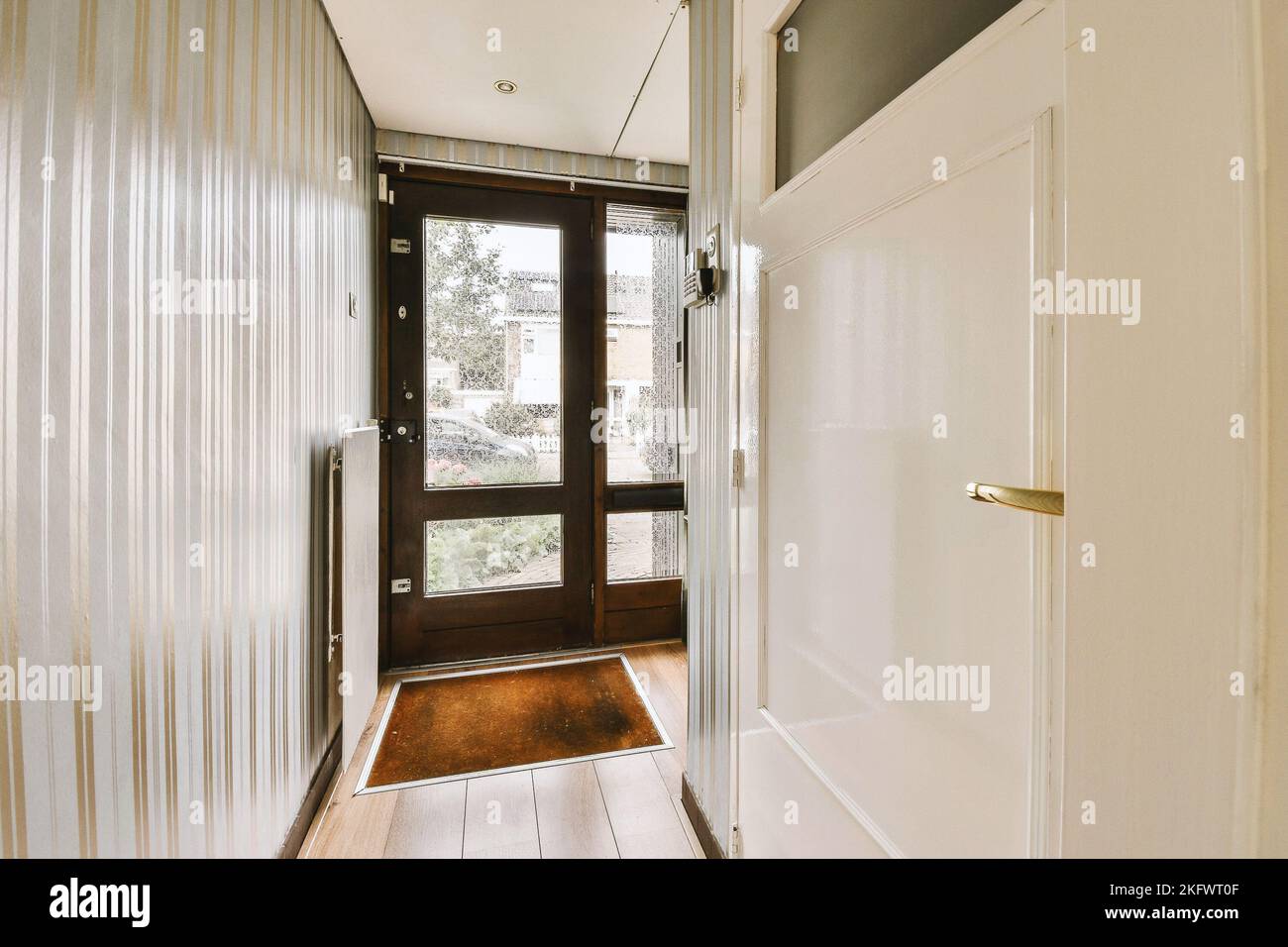 Light narrow hallway with many doors in white walls and glowing lamp ...