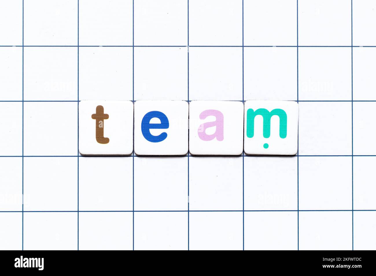 Colorful tile letter in word team on white grid background Stock Photo ...