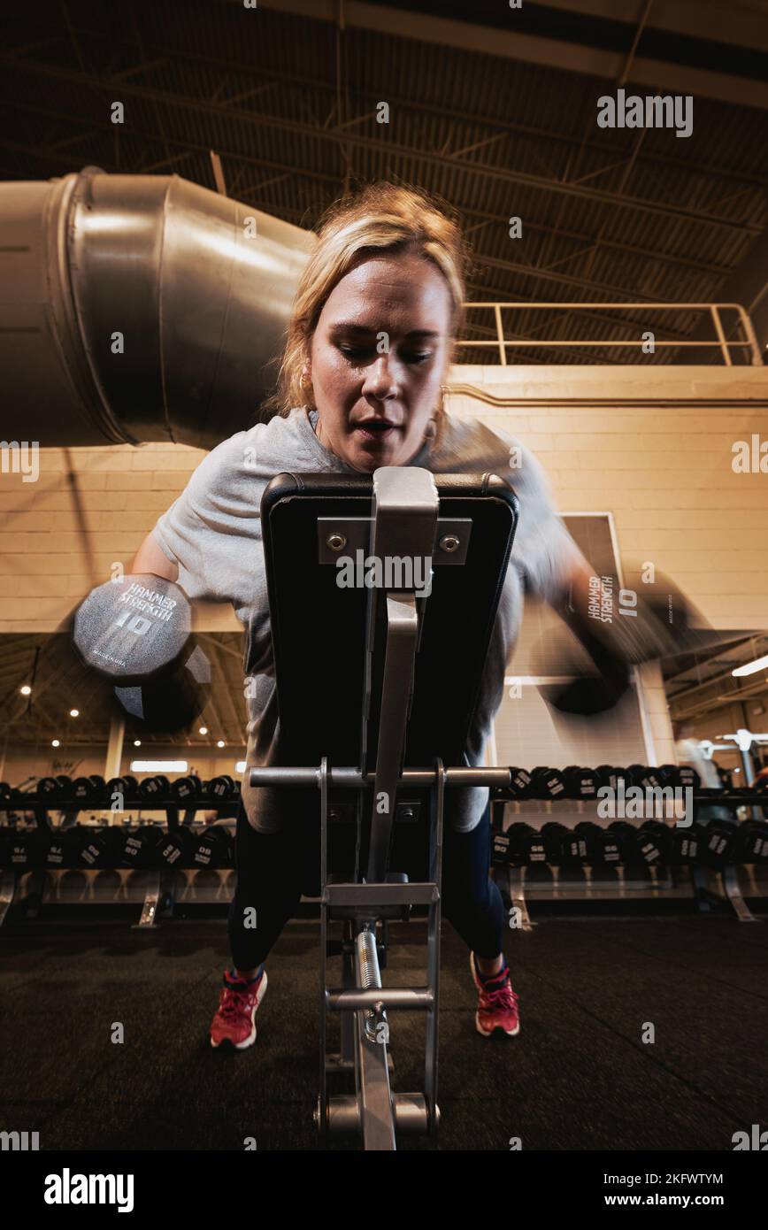 Cari Kelley, Mix 107.5 radio host, performs dumbbell rows while ...