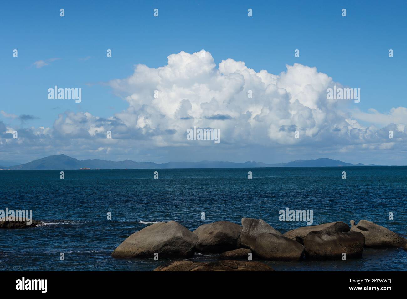 A beautiful shot of the rocky seashore under a bright sky on Shanwei ...