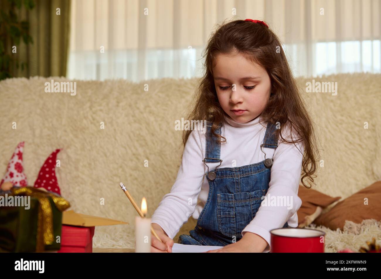 Cute Child A Lovely Little Girl Writing A Christmas Wish Letter To cute-child-a-lovely-little-girl-writing-a-christmas-wish-letter-to