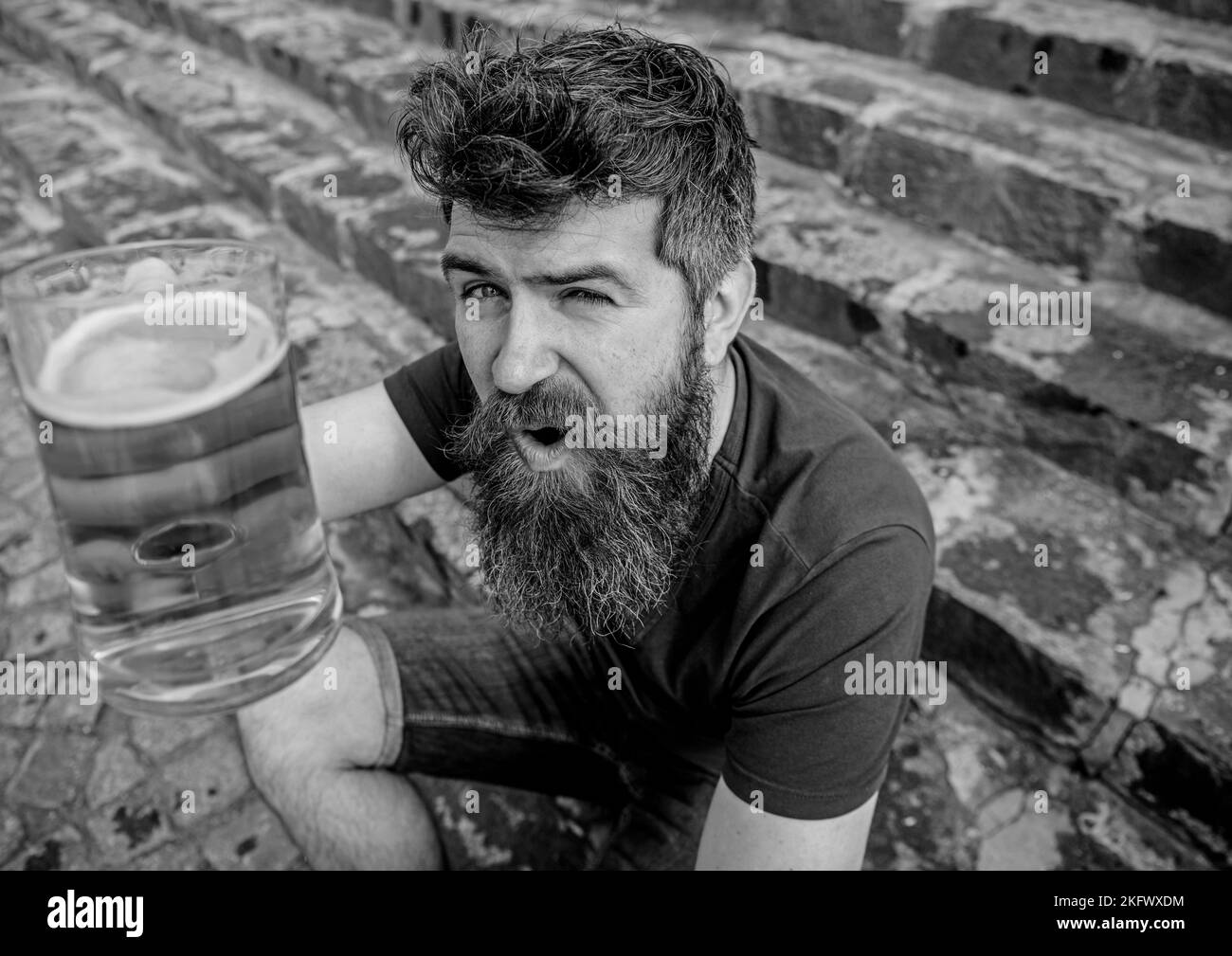 Guy having rest with cold draught beer. Hipster on cheerful face ...