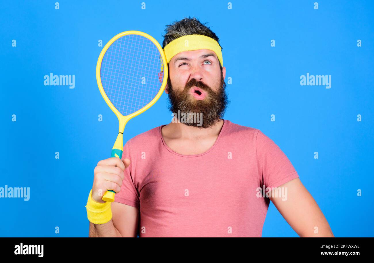 Athlete hold tennis racket in hand on blue background. Tennis club ...
