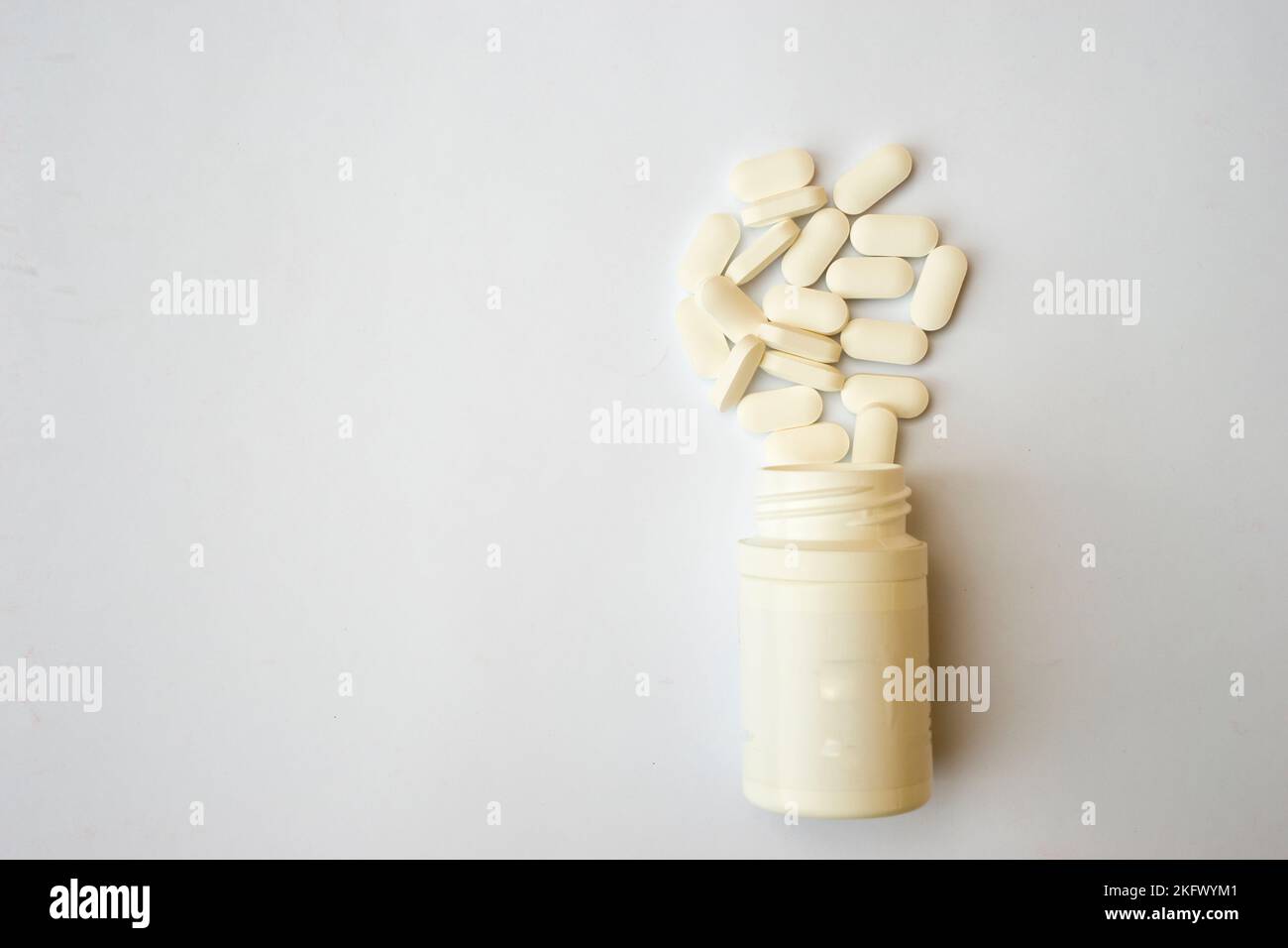 The medicine bottle and drug tablets isolated on white background ...