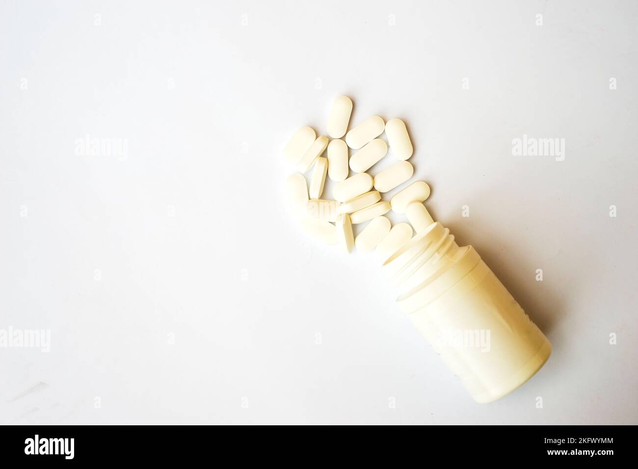 The medicine bottle and drug tablets isolated on white background ...