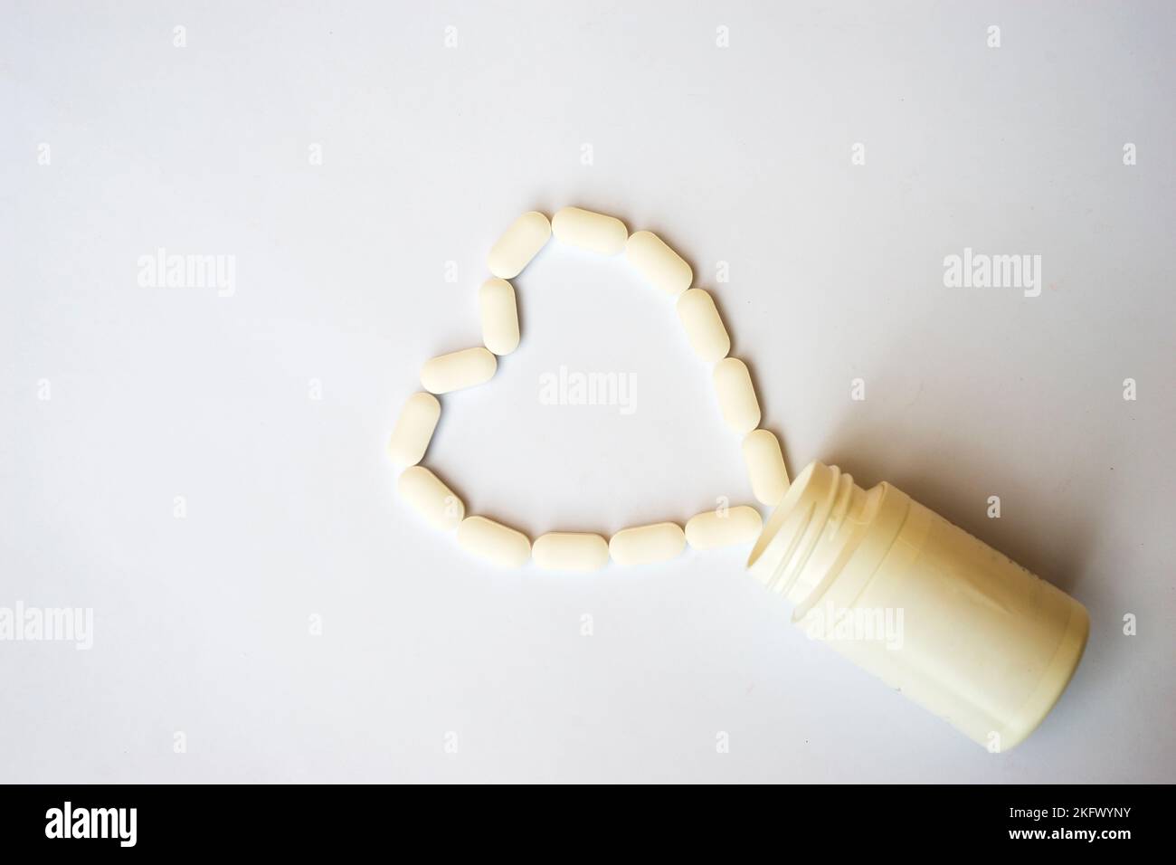 The medicine bottle and drug tablets isolated on white background ...