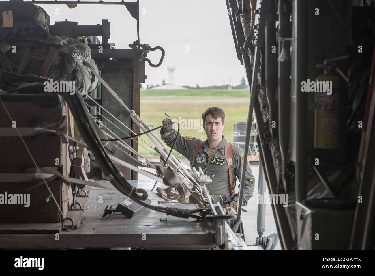 Staff Sgt. Tyler Renteria, 36th Airlift Squadron loadmaster, directs a ...
