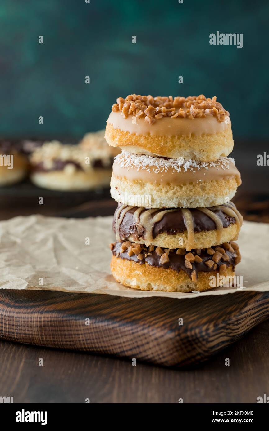 Close up of a stack of fresh homemade donuts with various toppings ...