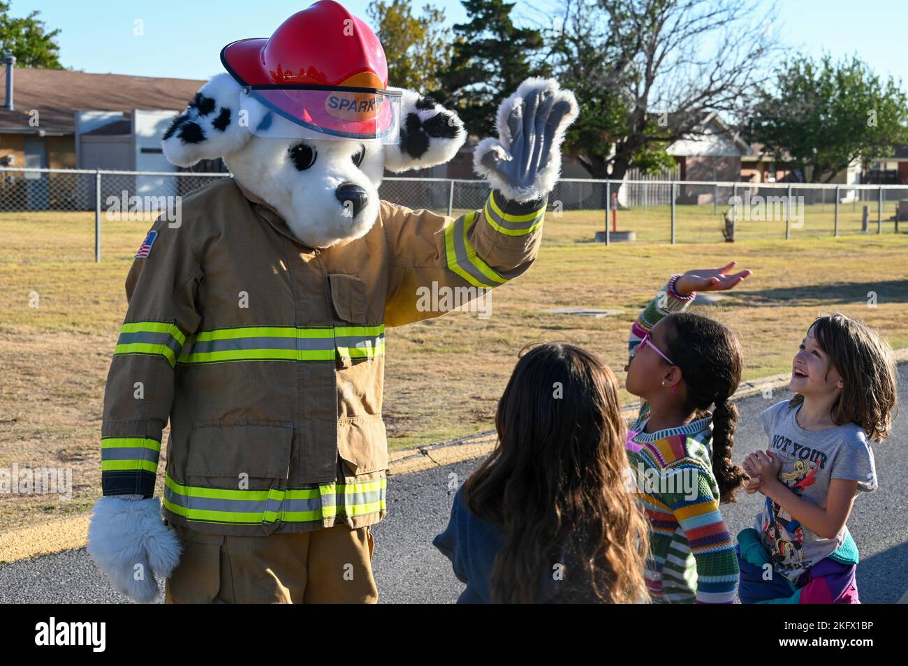 Sparky, 97th Civil Engineer Squadron fire safety mascot, gives a high ...