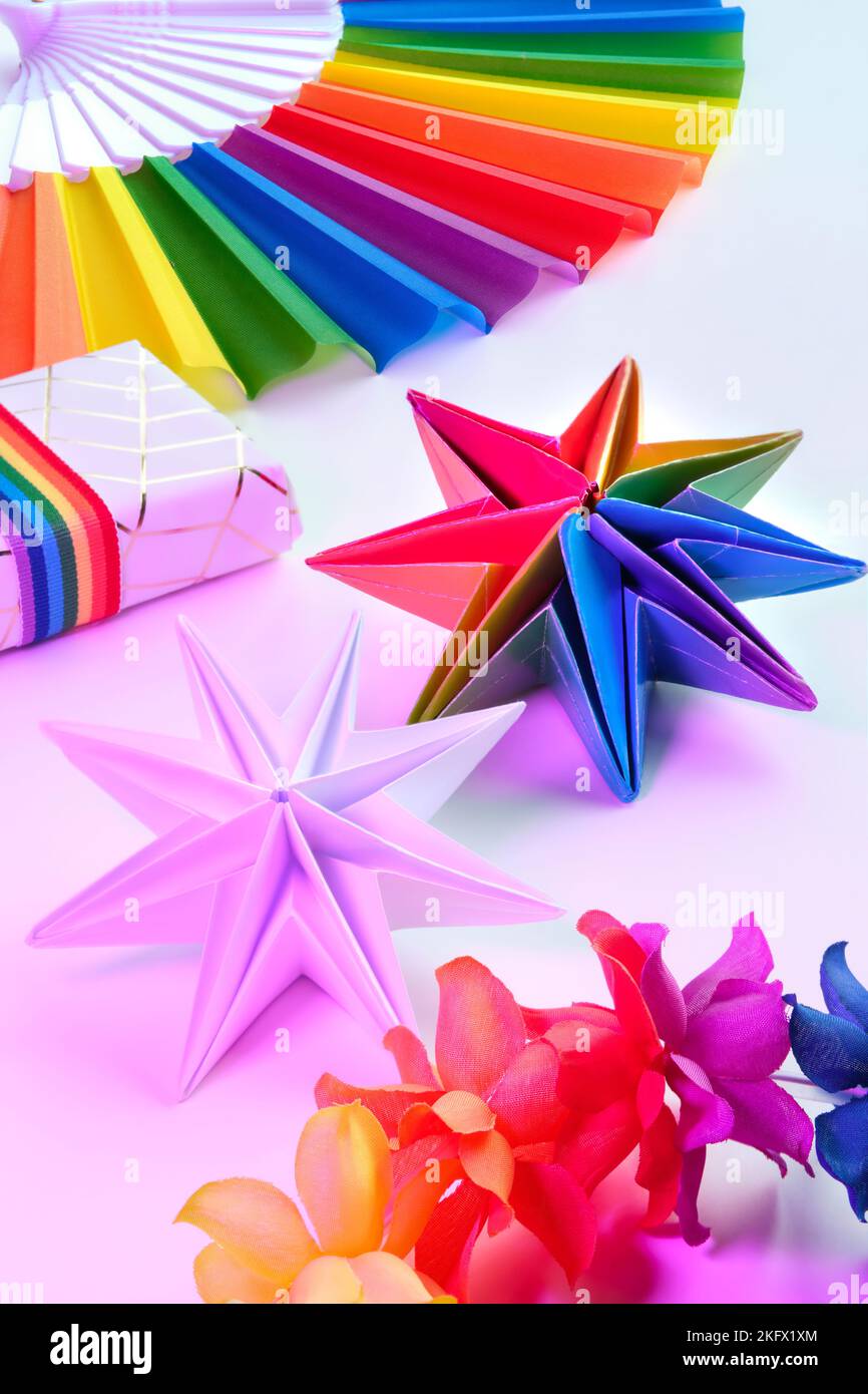 Vibrant neon rainbow origami paper stars. LGBTQ community rainbow flag ...