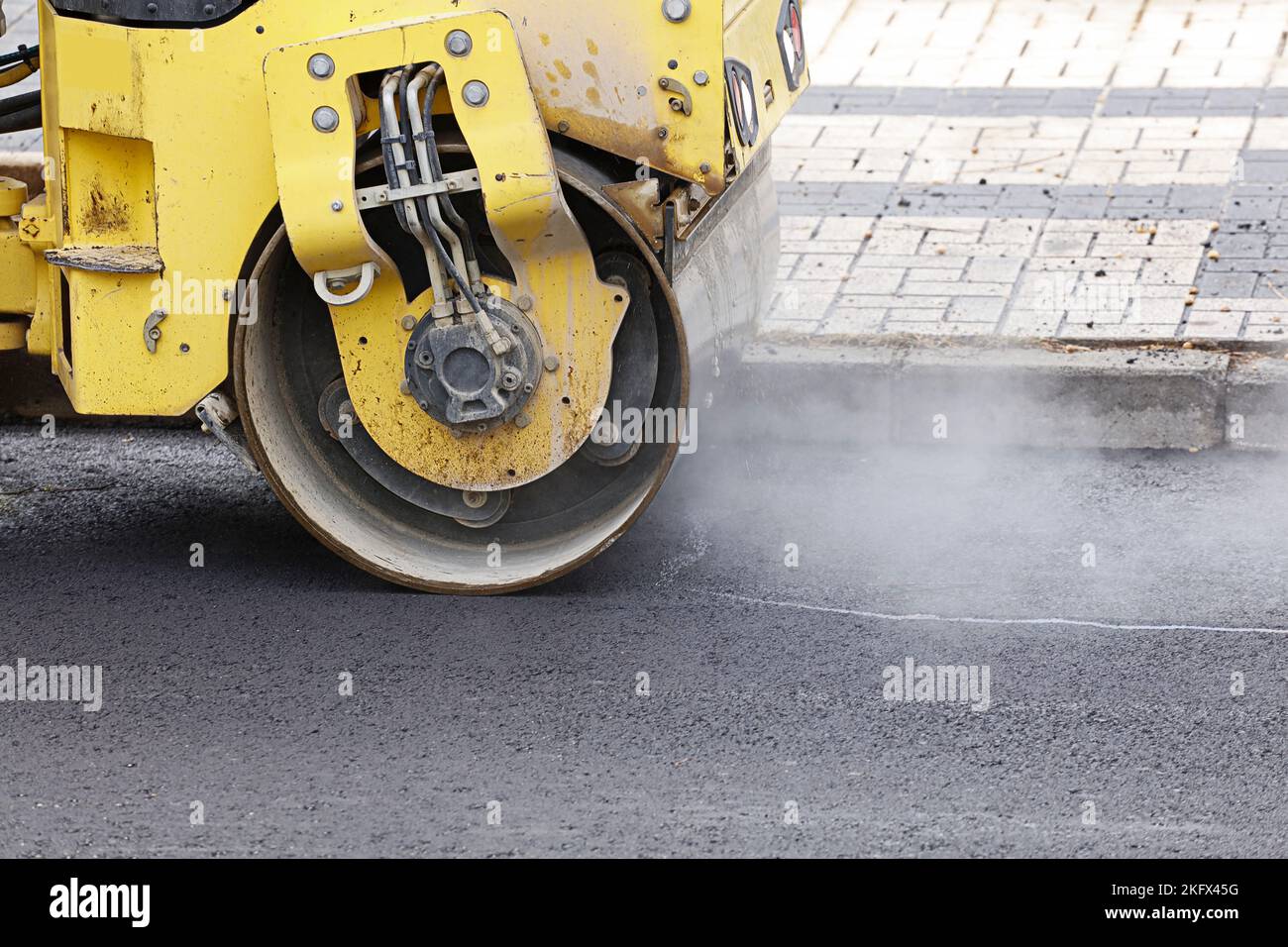 Road roller and asphalt paving machine at construction site Stock Photo ...