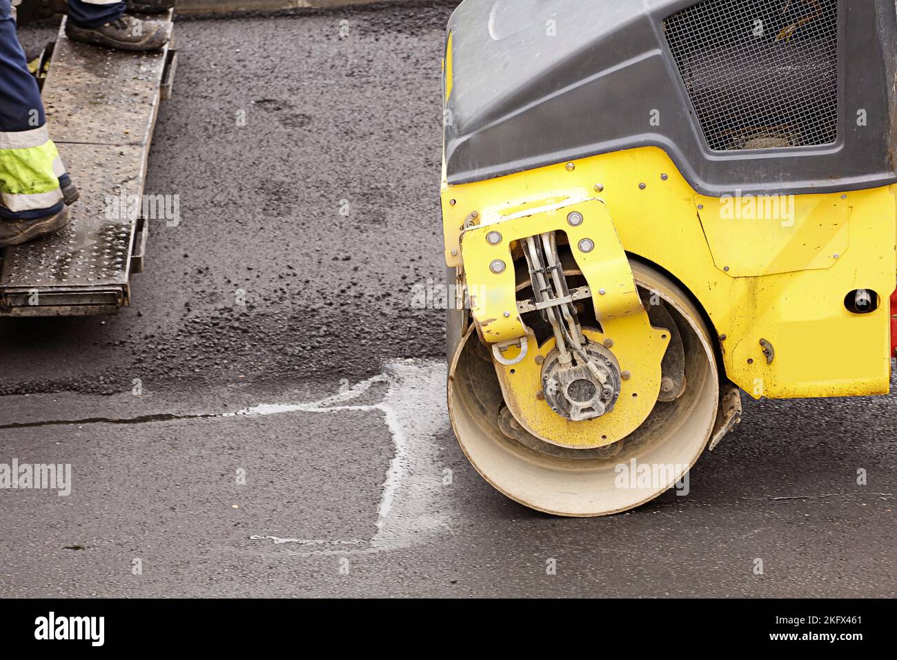 Road roller and asphalt paving machine at construction site Stock Photo ...
