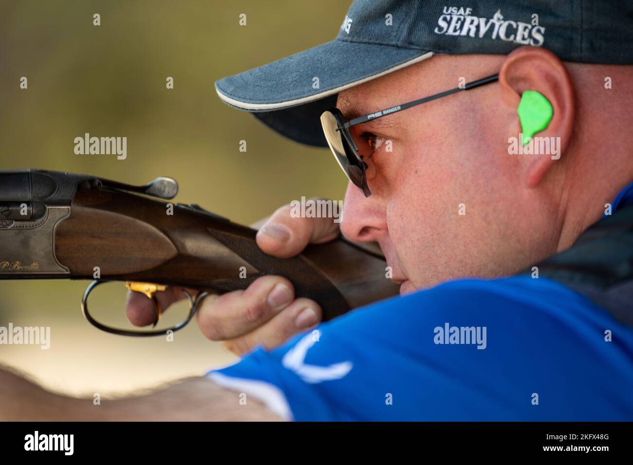U.S. Air Force Major Daniel Rich, Air Force Services Center, aims his ...