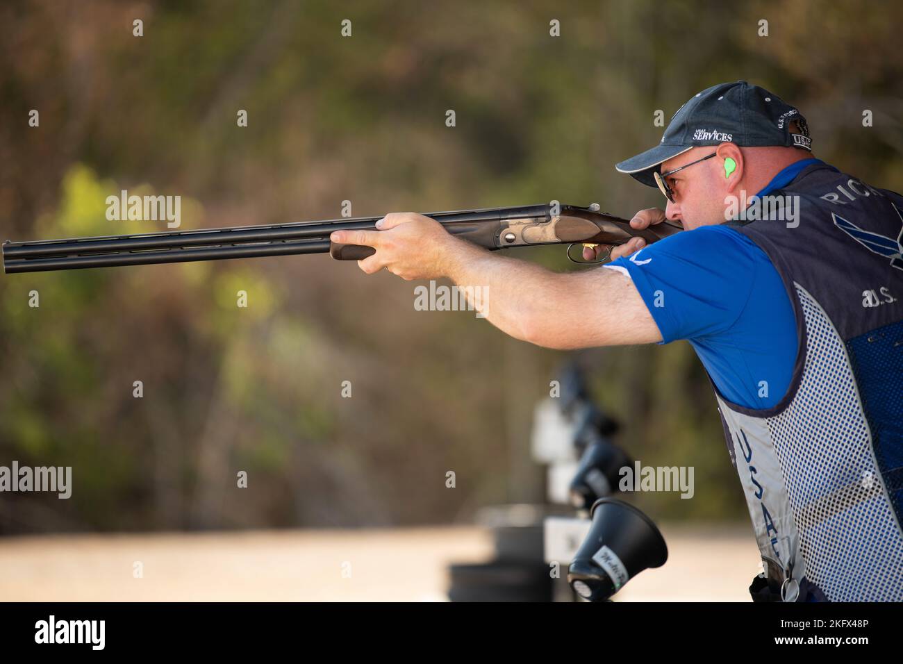 U.S. Air Force Major Daniel Rich, Air Force Services Center, aims his ...