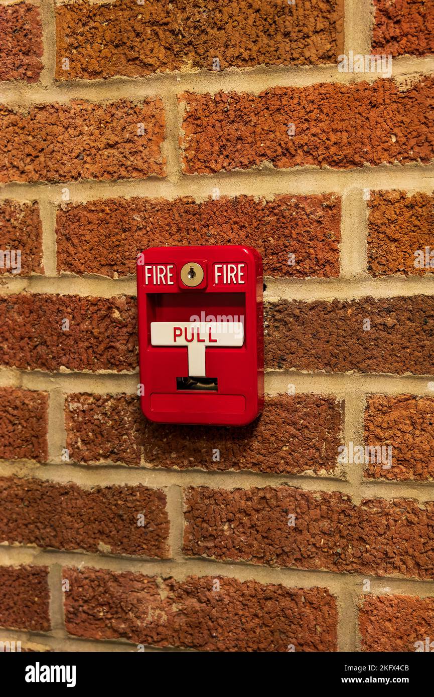 Manual fire alarm activation pull station on masonry wall Stock Photo ...