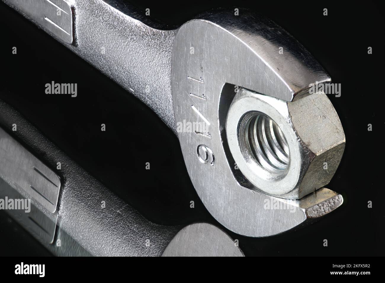 Open End Wrench and Nut on dark background Stock Photo - Alamy