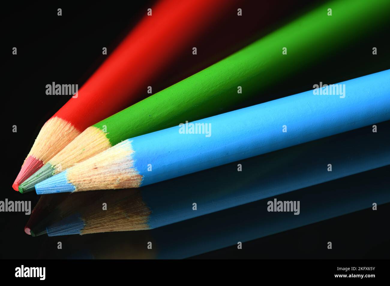 Bright Colored pencils on dark reflective glass Stock Photo - Alamy