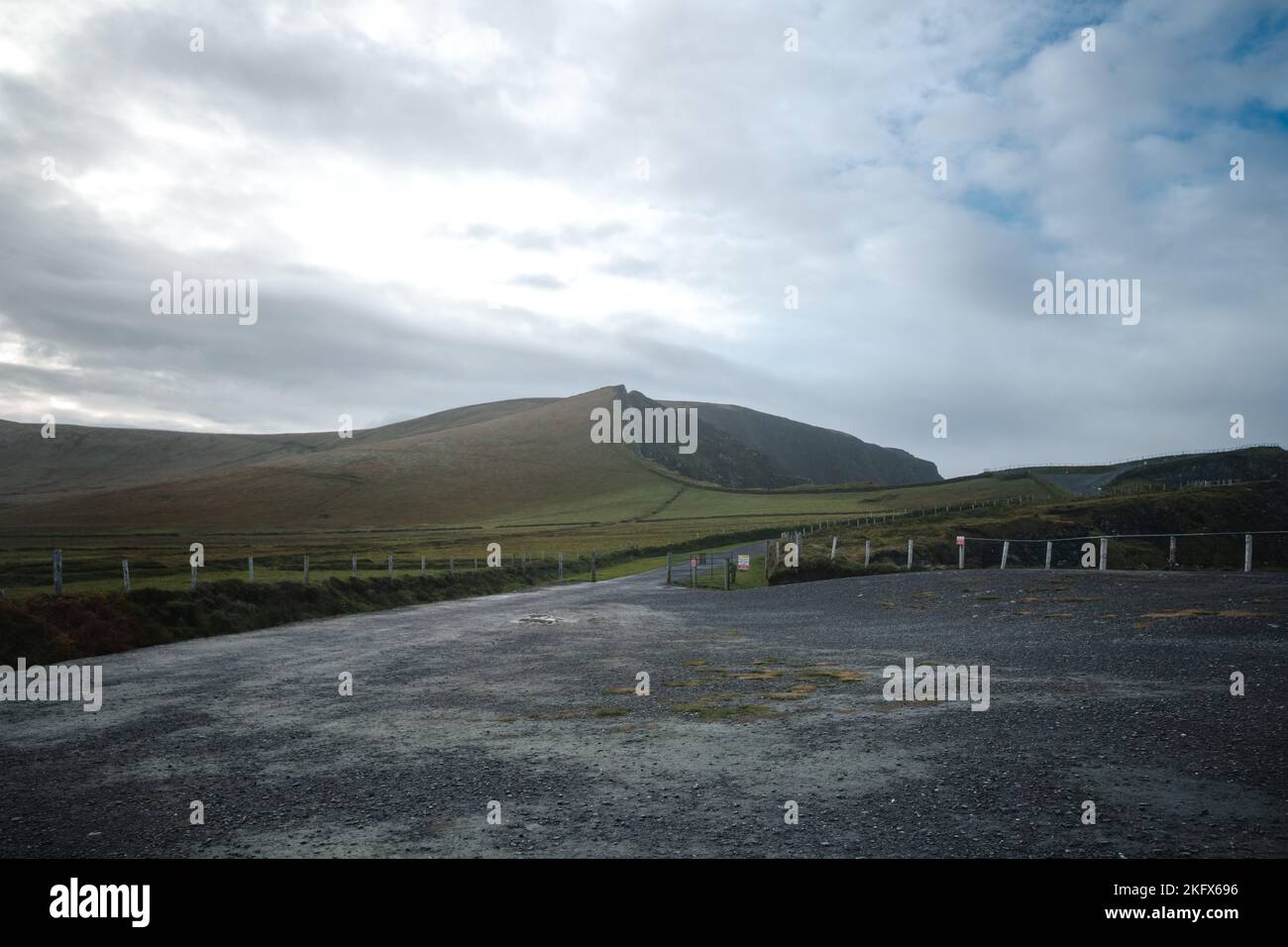Kerry cliffs with green grass and dramatic clouds in cloudy autumn day ...