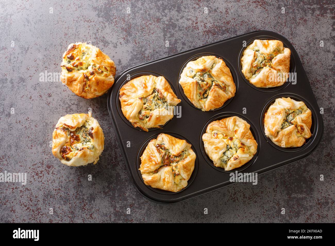 homemade feta cheese puff muffins with spinach closeup in the maffin ...