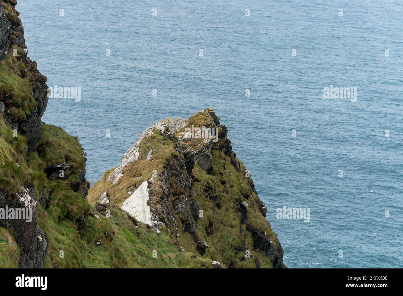 Kerry cliffs with green grass and dramatic clouds in cloudy autumn day ...