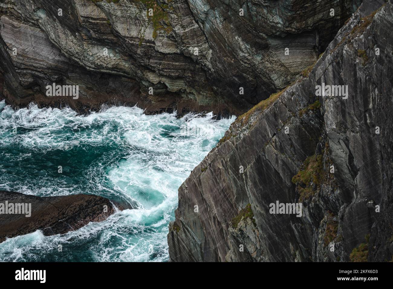 Kerry cliffs with green grass and dramatic clouds in cloudy autumn day ...