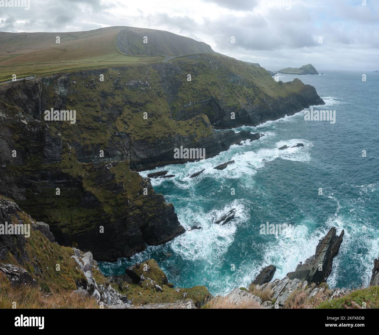 Kerry cliffs with green grass and dramatic clouds in cloudy autumn day ...