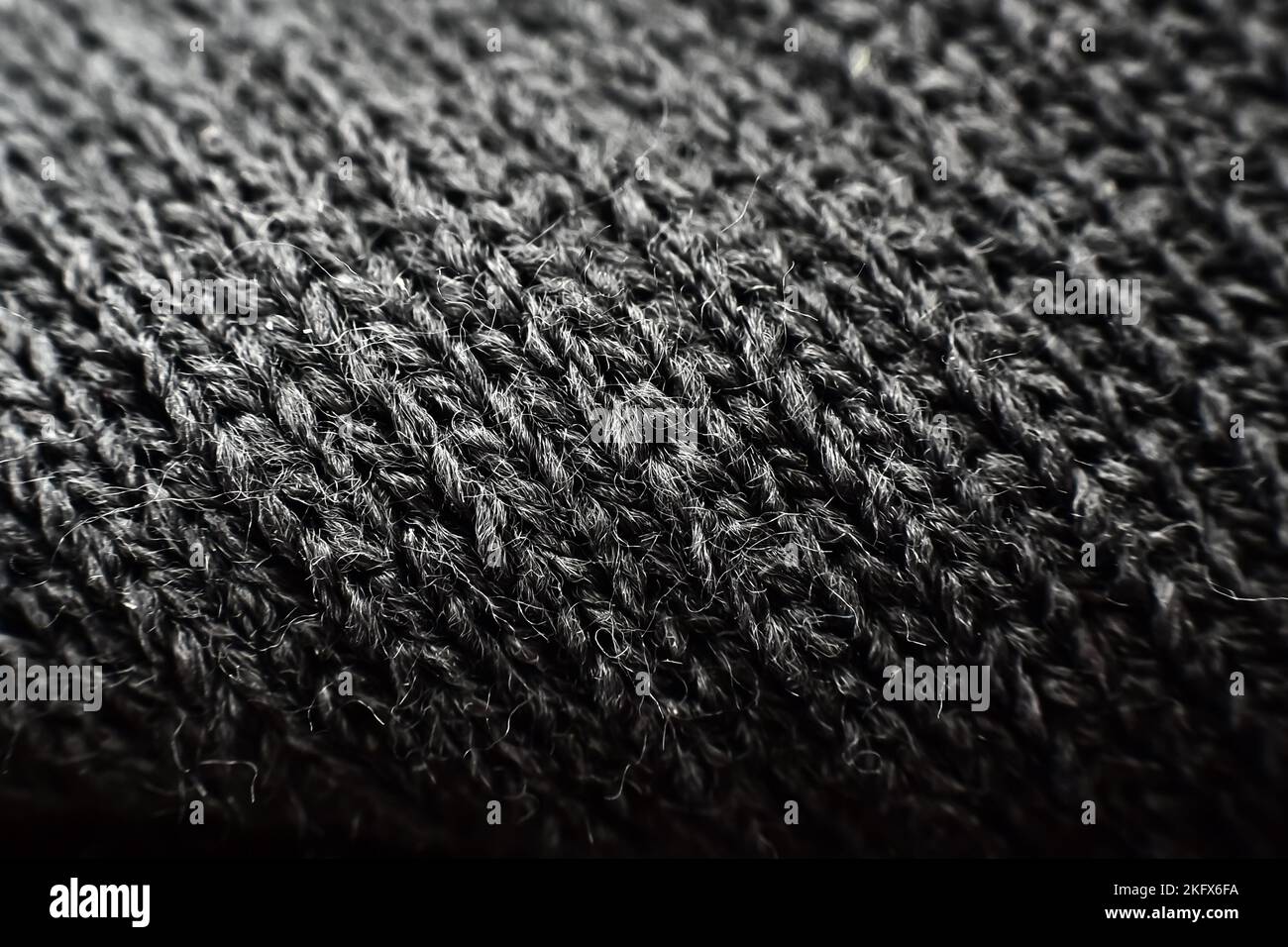 Texture of knitted fabric in dark color. Knitted material background ...