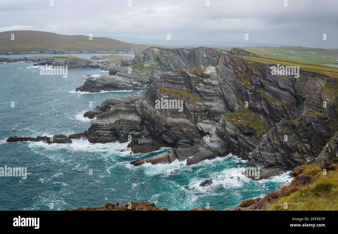 Kerry cliffs with green grass and dramatic clouds in cloudy autumn day ...