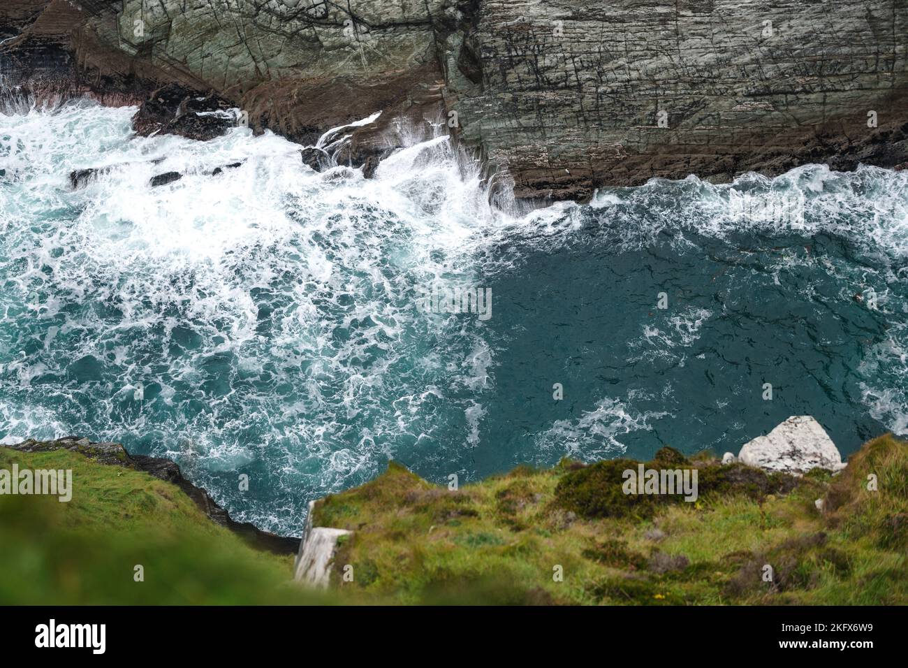 Kerry cliffs with green grass and dramatic clouds in cloudy autumn day ...