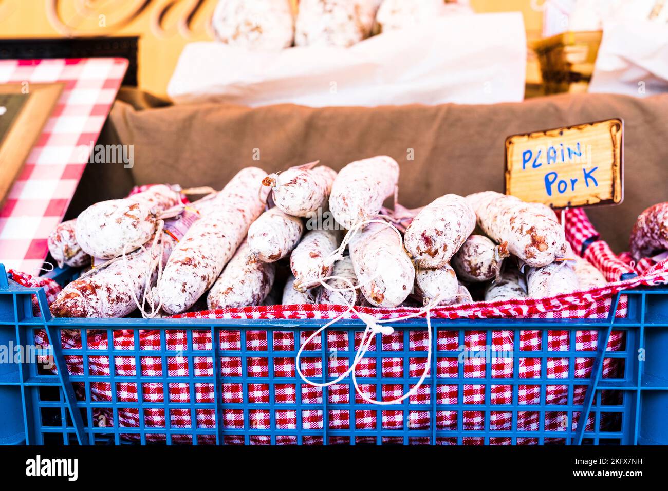 Red and white clothe with French dried meat saucisson sec sausages ...