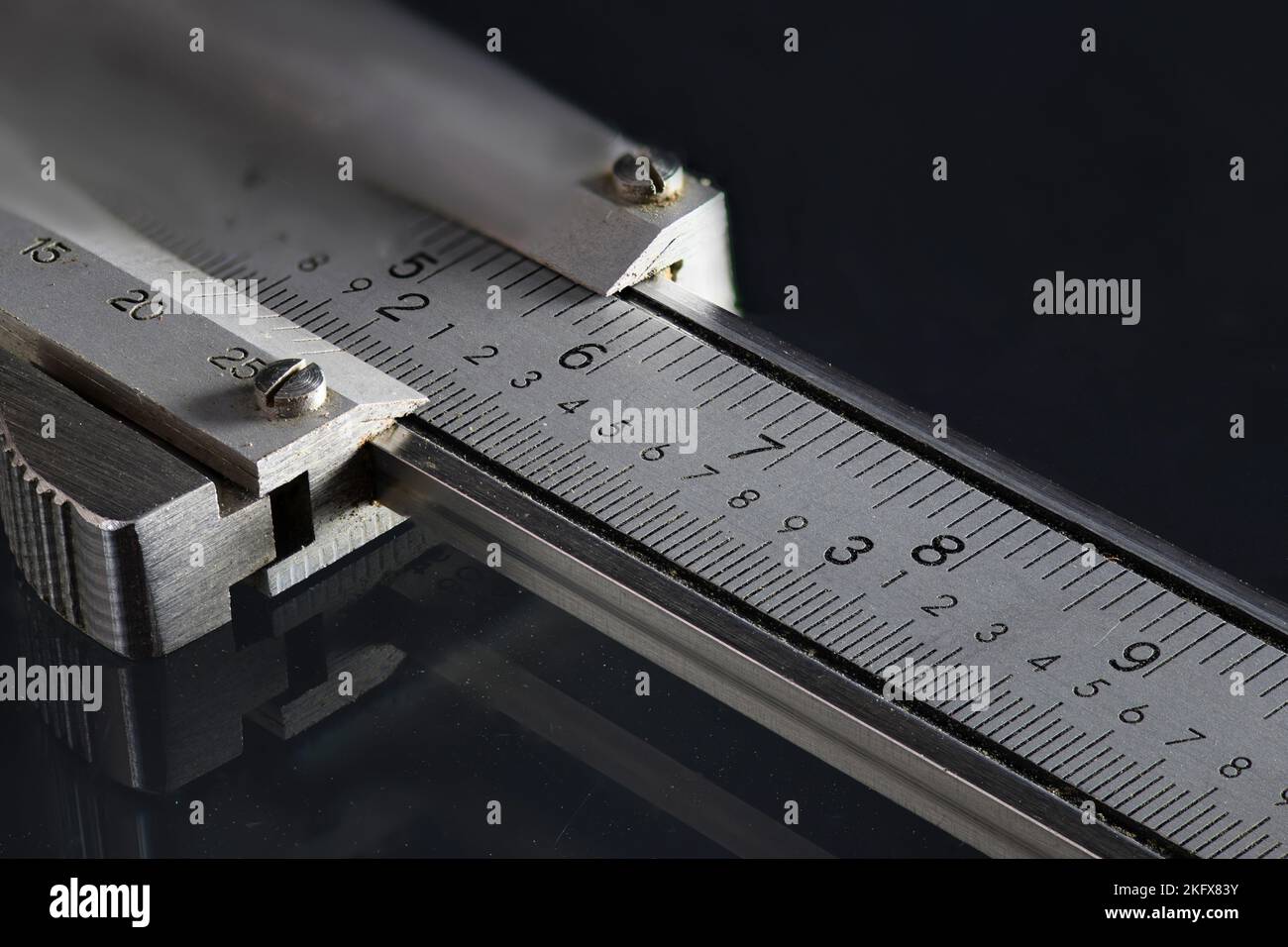 Caliper close up on dark glass Stock Photo - Alamy