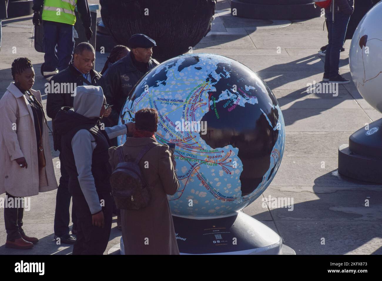 London, UK. 20th Nov, 2022. Visitors admire a globe exhibited on ...