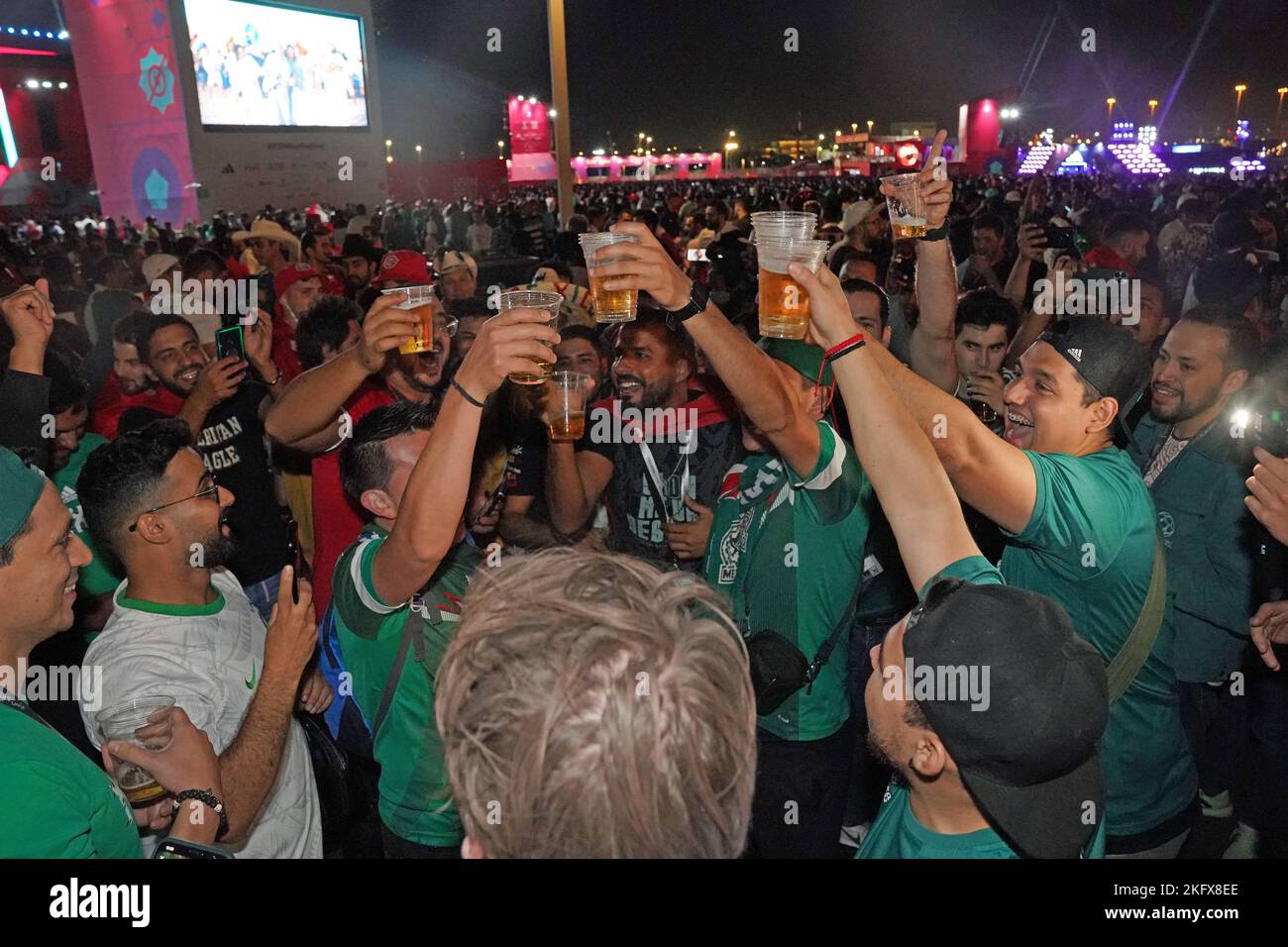 Mexican and Dutch fans enjoy a beer at the FIFA Fan Festival in Al Bidda Park in Doha, Qatar ...