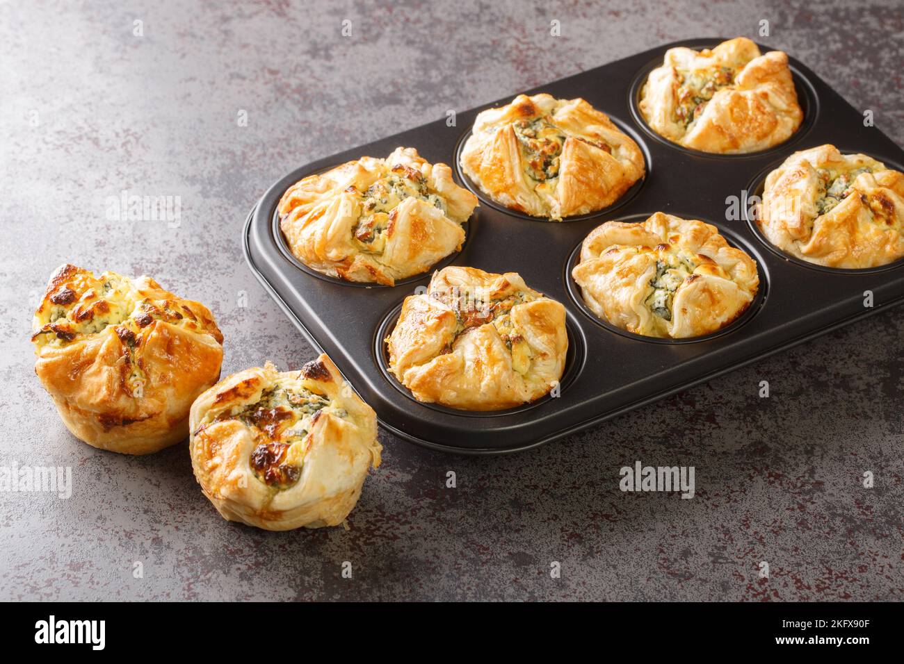 homemade feta cheese puff muffins with spinach closeup in the maffin ...