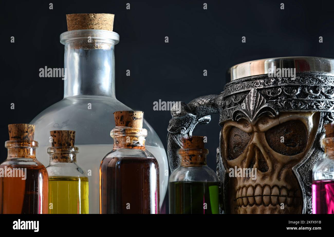 Colored Oil bottles on a black background Stock Photo - Alamy