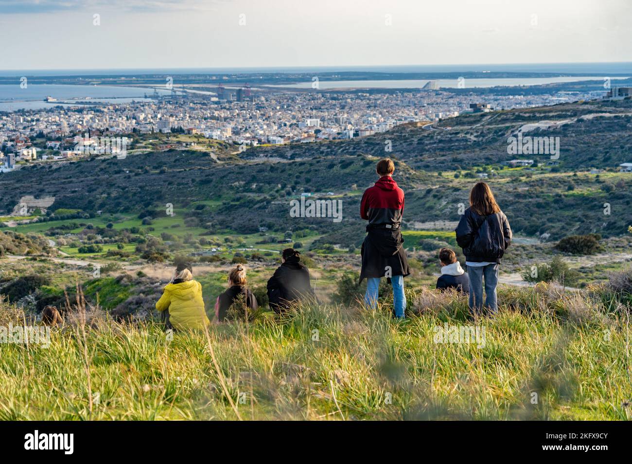 A group of hikers resting on a hill with fresh grass Stock Photo - Alamy