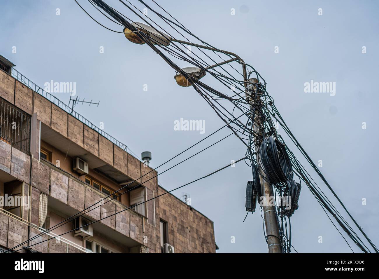 A low angle of electric wires on lamp post in front of building Stock ...