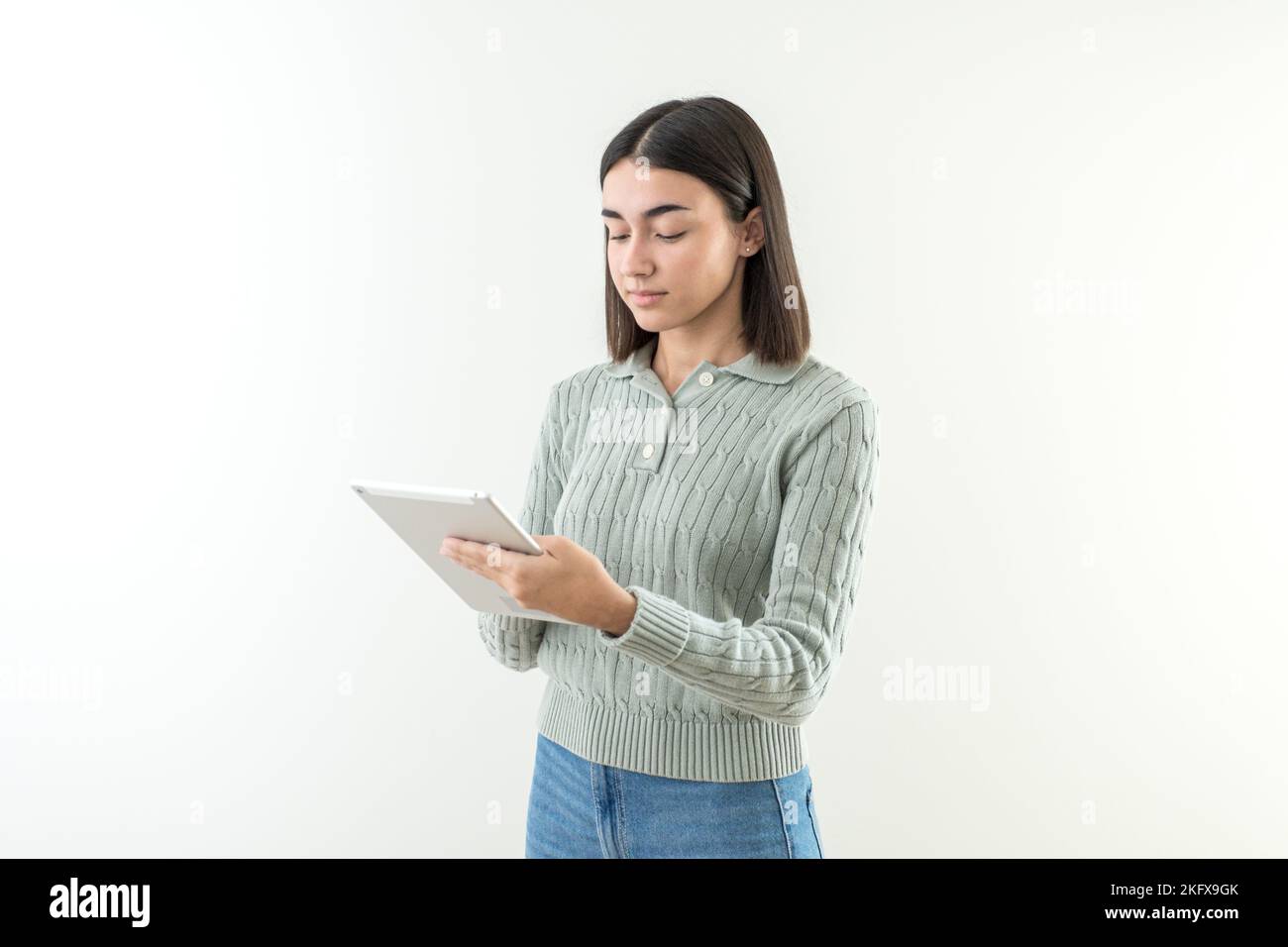 Young girl with short hair looking at tablet Stock Photo - Alamy