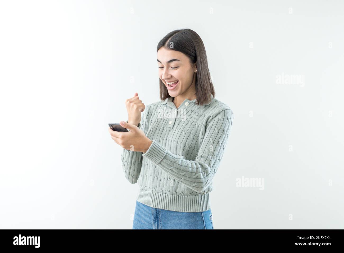 Happy and smiling young girl reads a good news on the tablet Stock ...